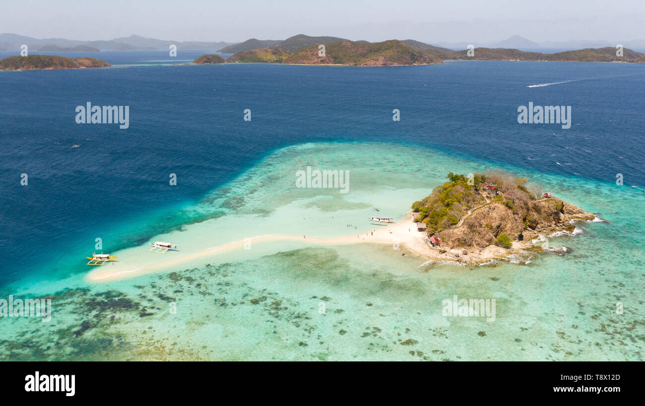 A small island for tourists with a sand bar.Tourists rest on a small ...