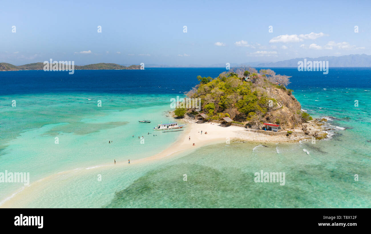 A small island for tourists with a sand bar.Tourists rest on a small ...