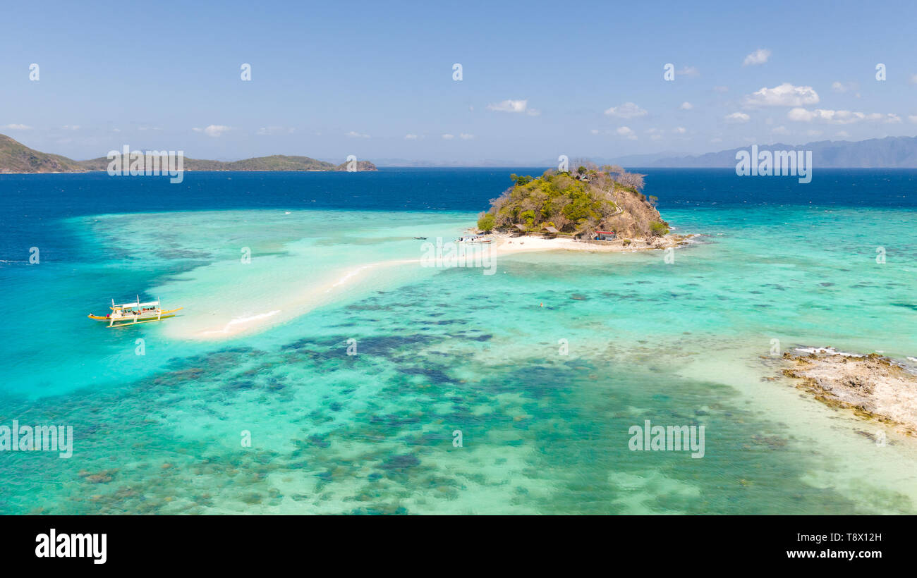 A small island for tourists with a sand bar.Tourists rest on a small ...