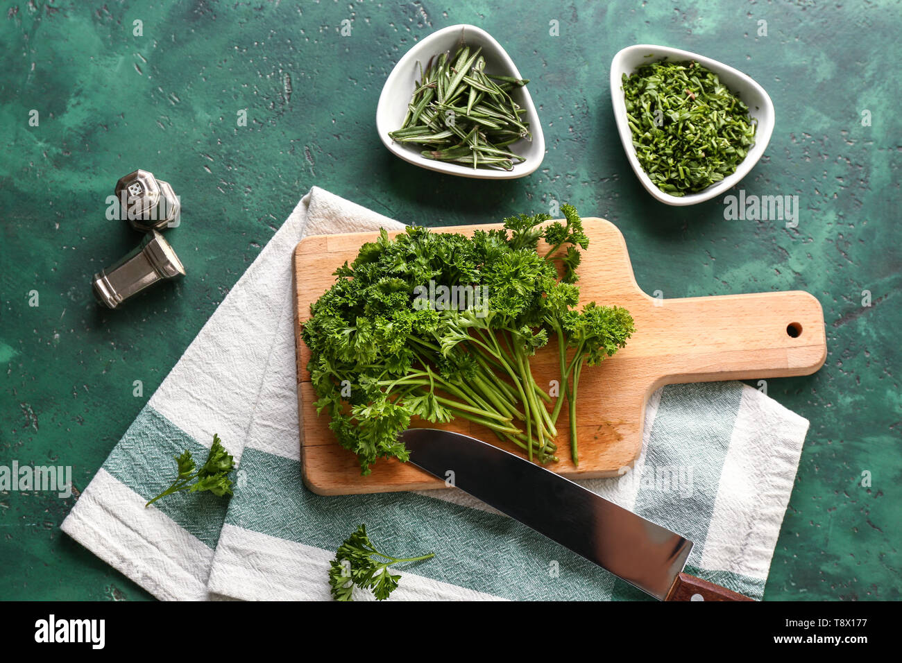 Fresh aromatic herbs with cutting board on color background Stock Photo ...