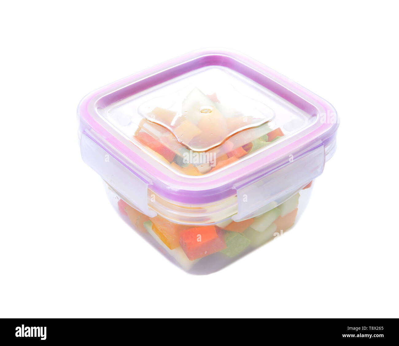 Plastic container with fresh vegetables for freezing on white ...