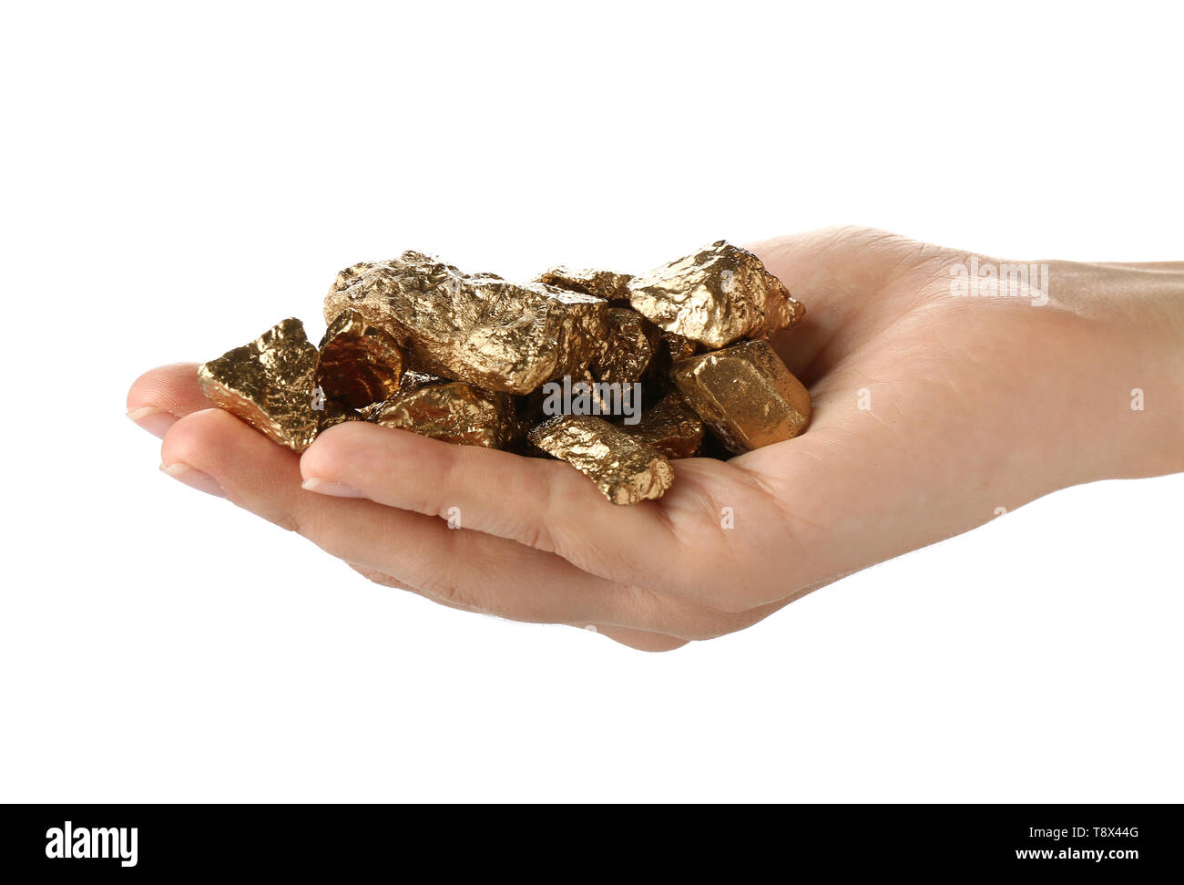 Female hand with gold nuggets on white background Stock Photo - Alamy