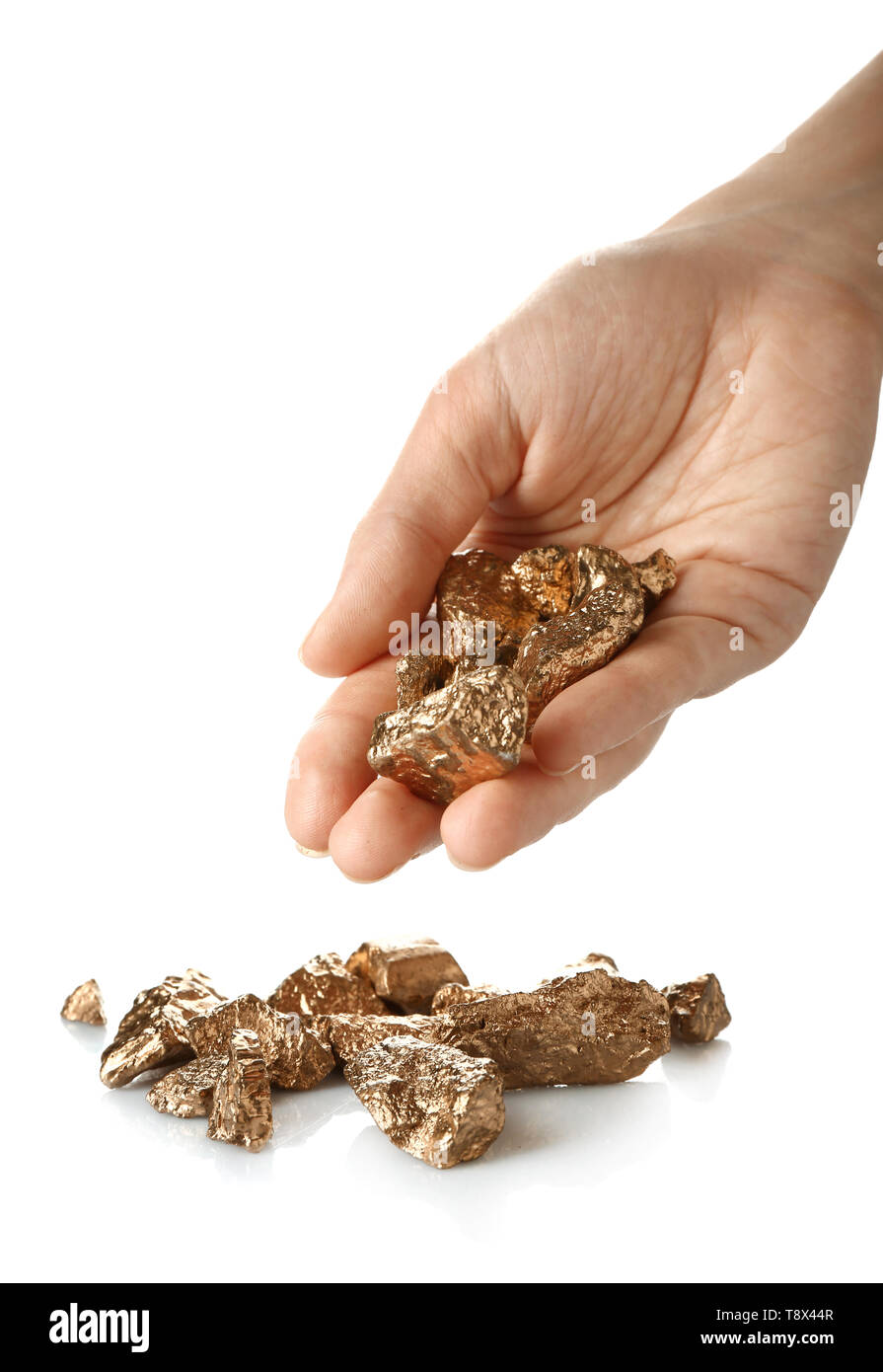 Female hand with gold nuggets on white background Stock Photo - Alamy