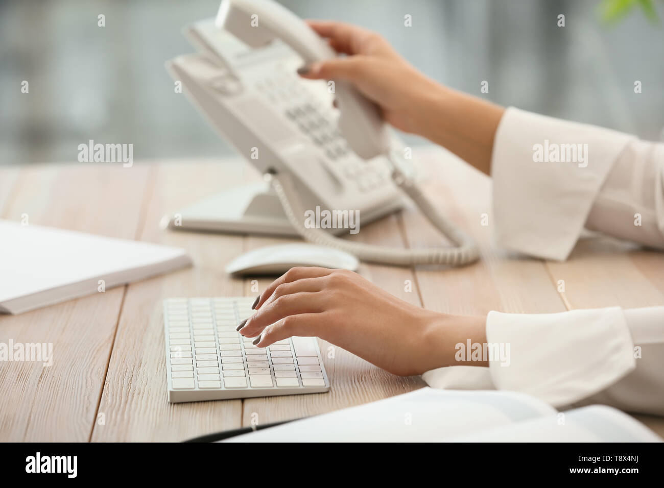 Female secretary working in office Stock Photo - Alamy