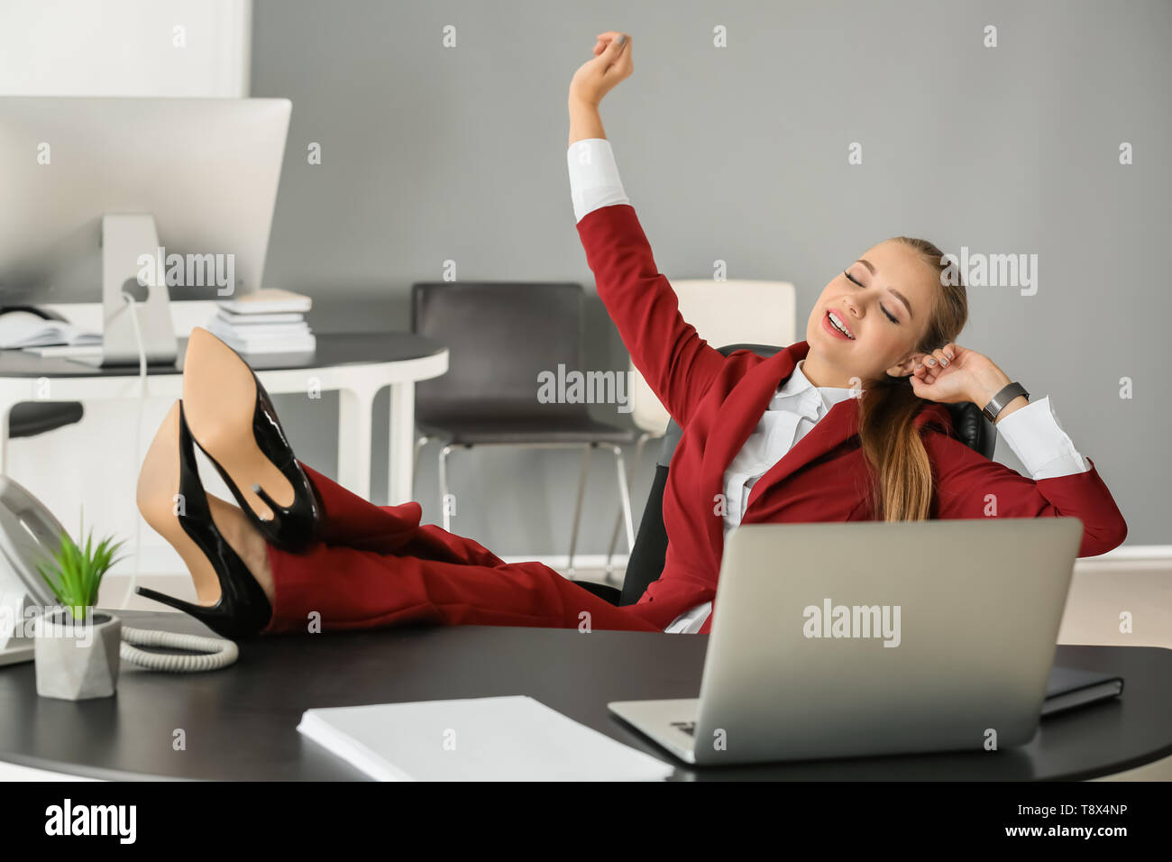 Beautiful female secretary resting at workplace Stock Photo - Alamy