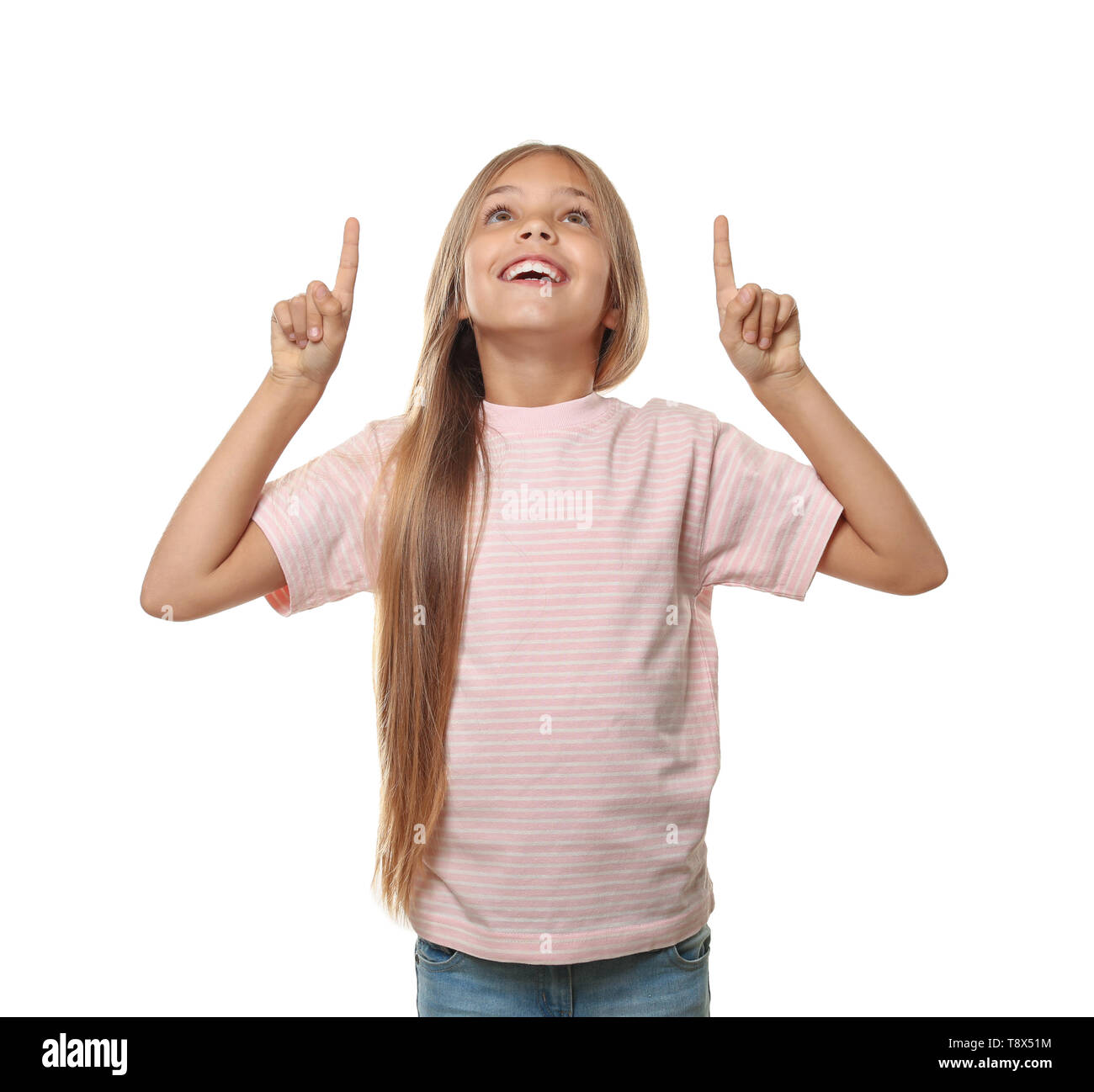 Little girl in t-shirt pointing at something on white background Stock ...