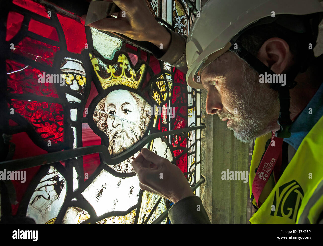 Conservation Manager Nick Teed removes a stained glass window during ...