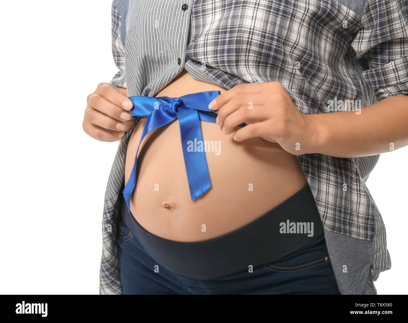 Beautiful pregnant woman with blue ribbon on her belly against white ...