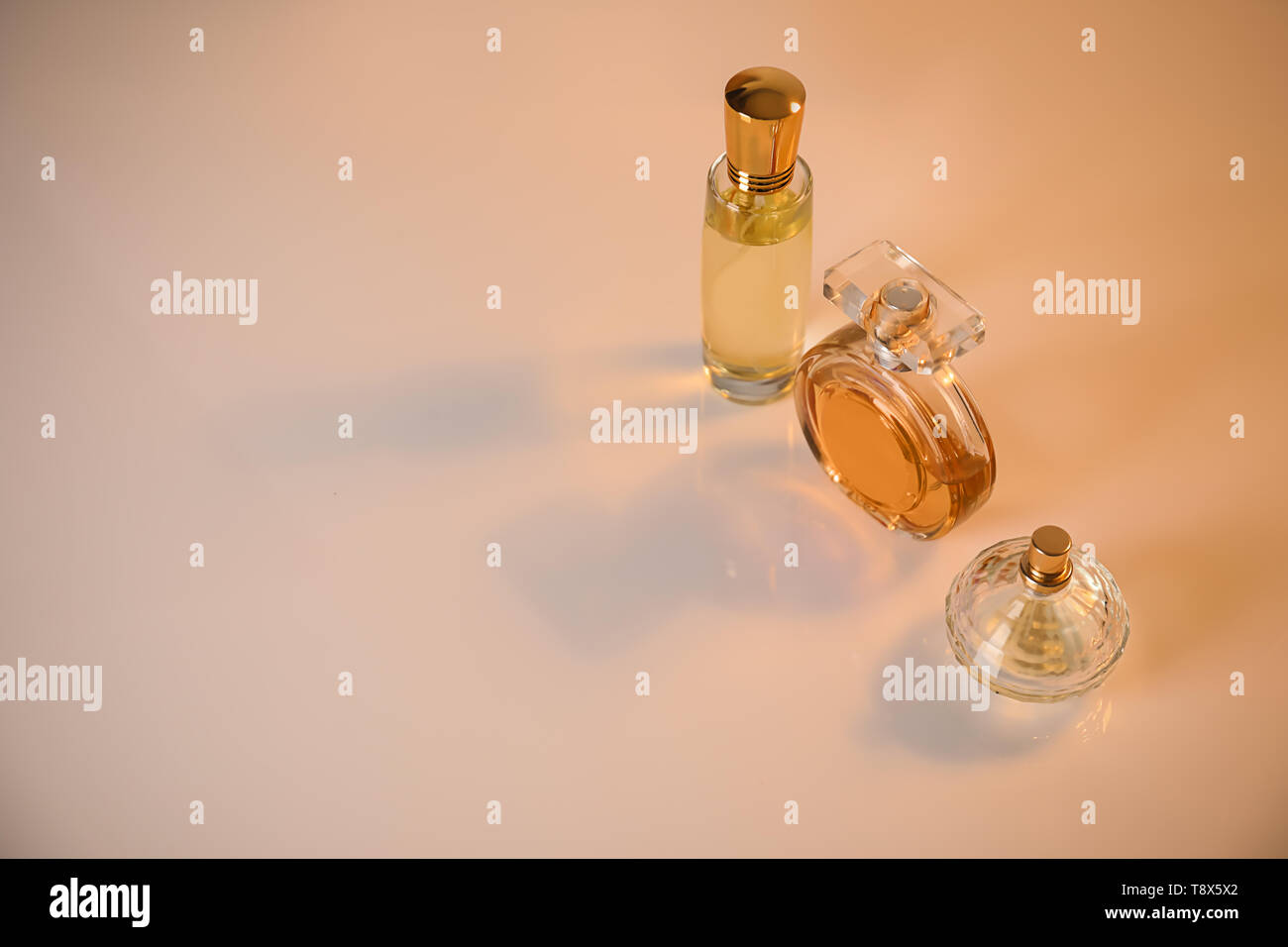 Bottles of perfume on light background Stock Photo - Alamy