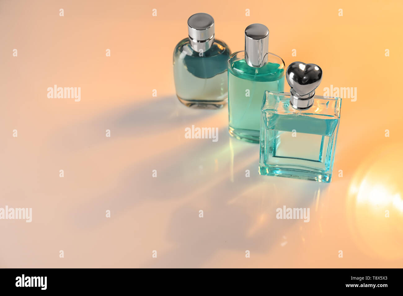 Bottles of perfume on light background Stock Photo - Alamy