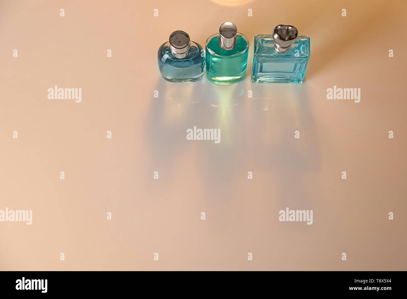 Bottles of perfume on light background Stock Photo - Alamy