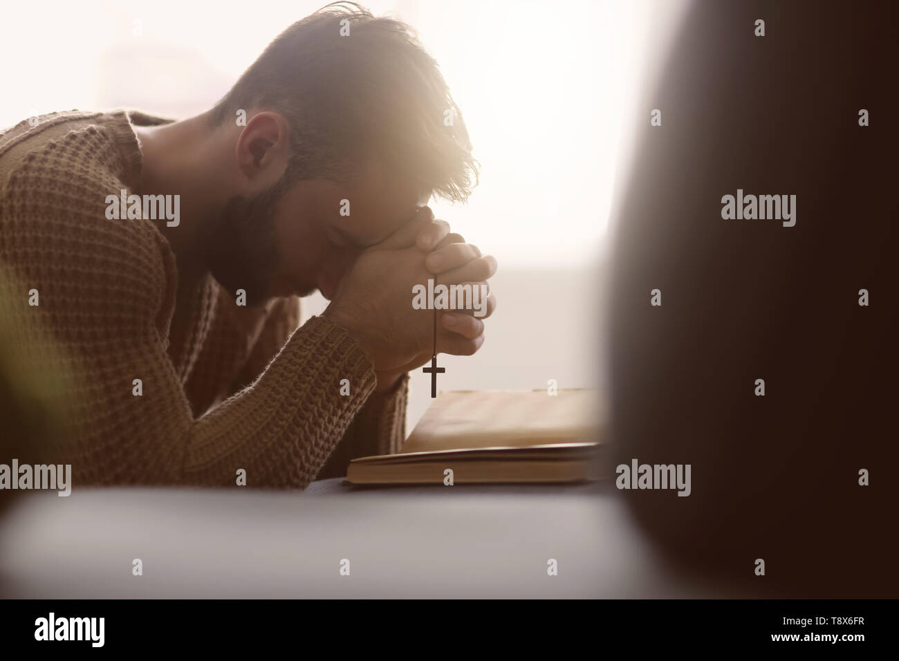 Religious young man praying to God at home Stock Photo - Alamy