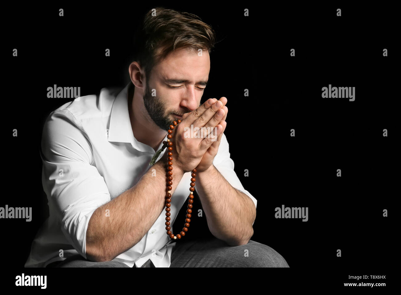 Young man praying hi-res stock photography and images - Alamy