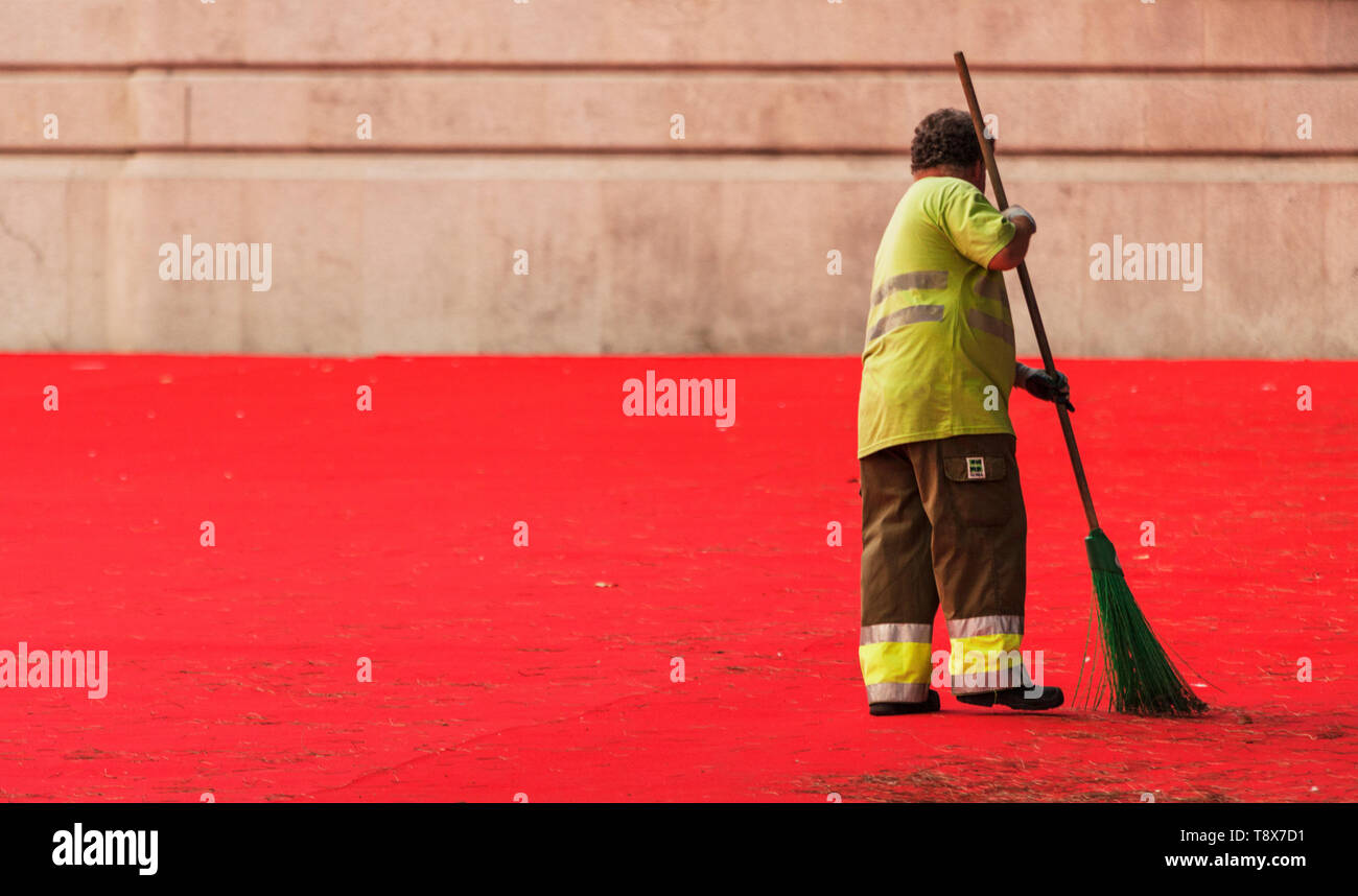 Man sweeping a red carpet in Porto Stock Photo - Alamy