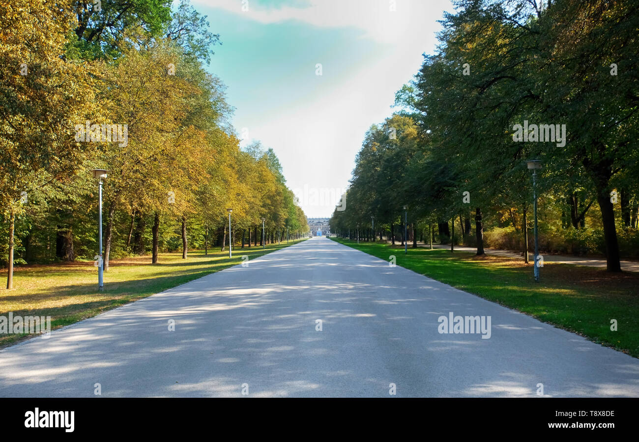 View on wide pathway in beautiful park Stock Photo - Alamy