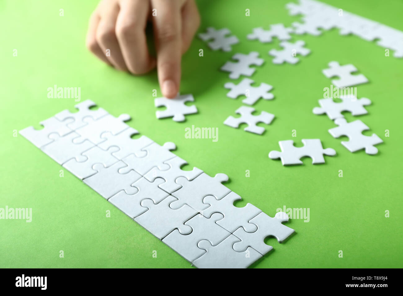 Young people doing jigsaw puzzle hi-res stock photography and images ...