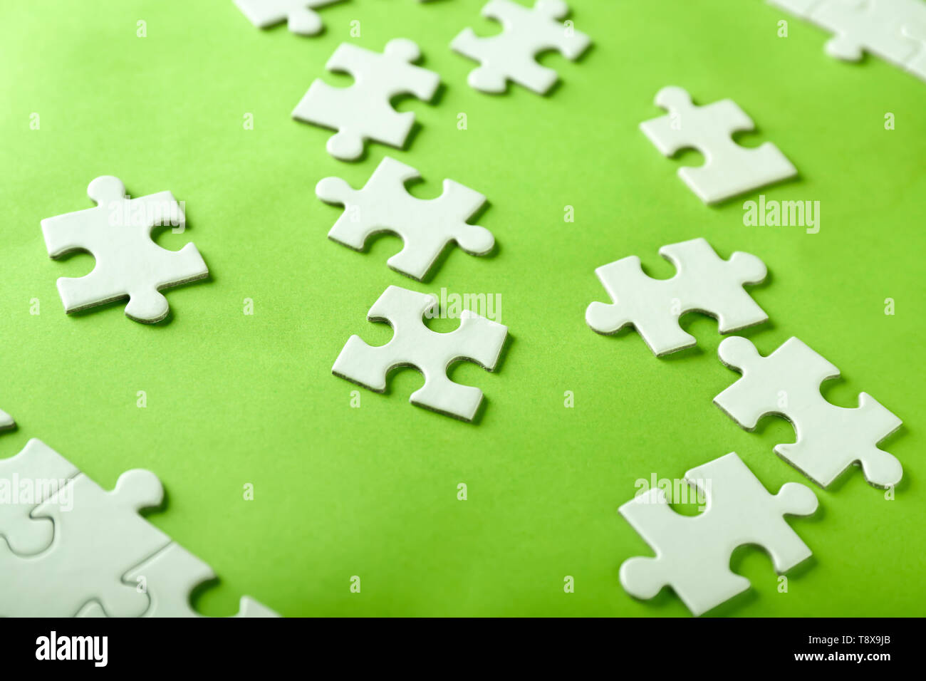 Pieces of jigsaw puzzle on color background Stock Photo - Alamy