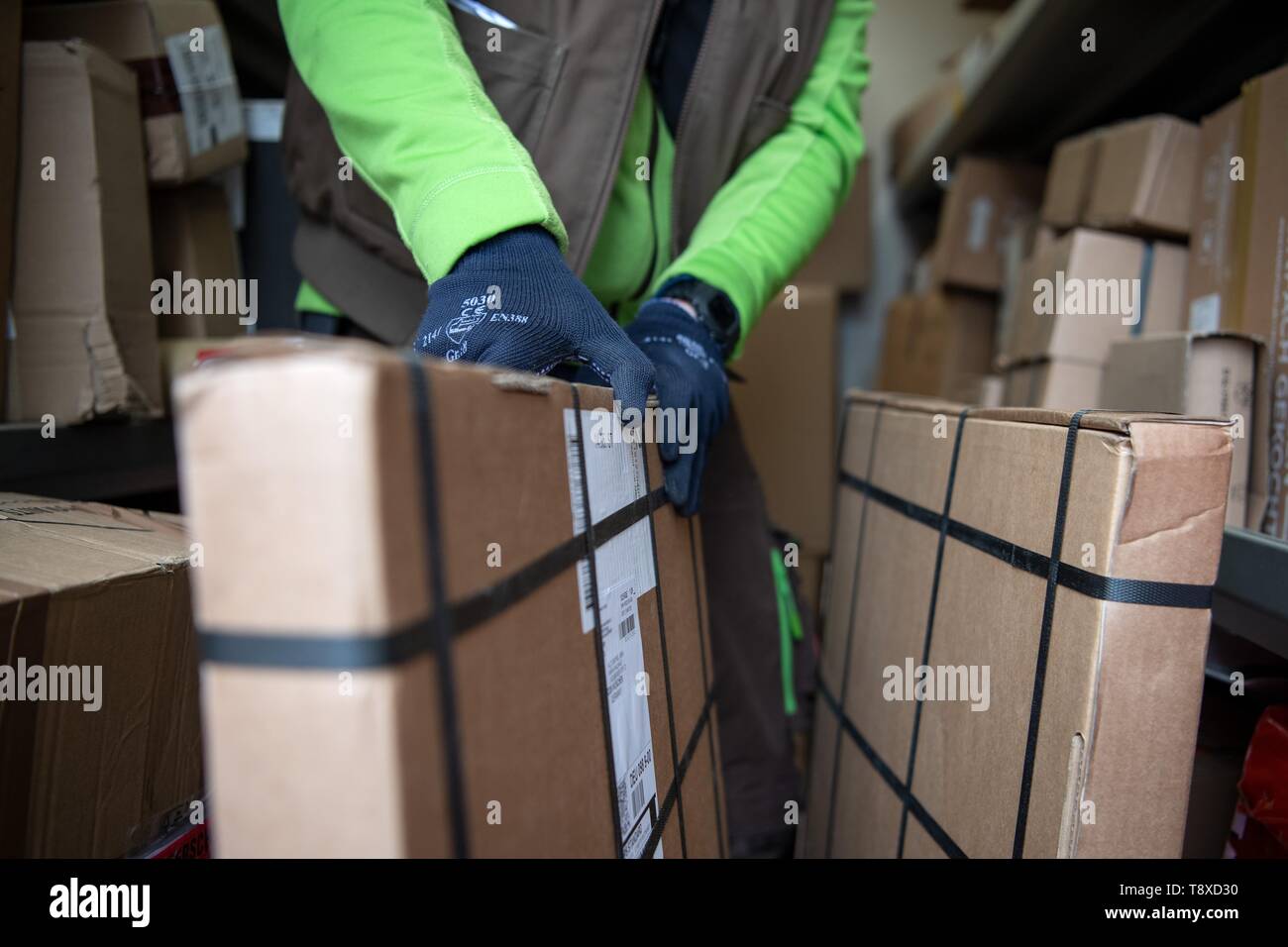 Munich, Germany. 15th May, 2019. A parcel carrier from UPS loads ...