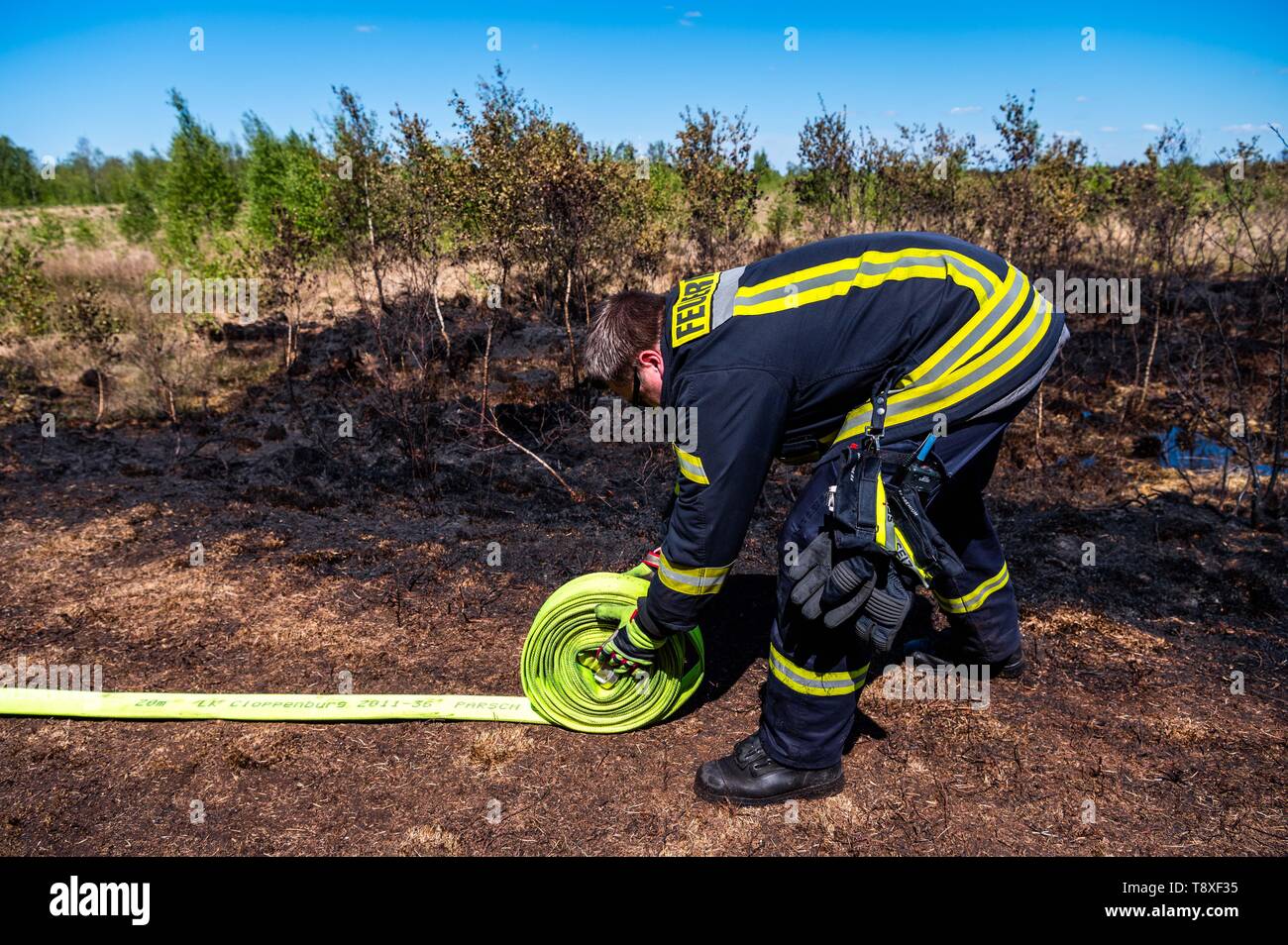 Firefighter rolls up fire hose hi-res stock photography and images - Alamy