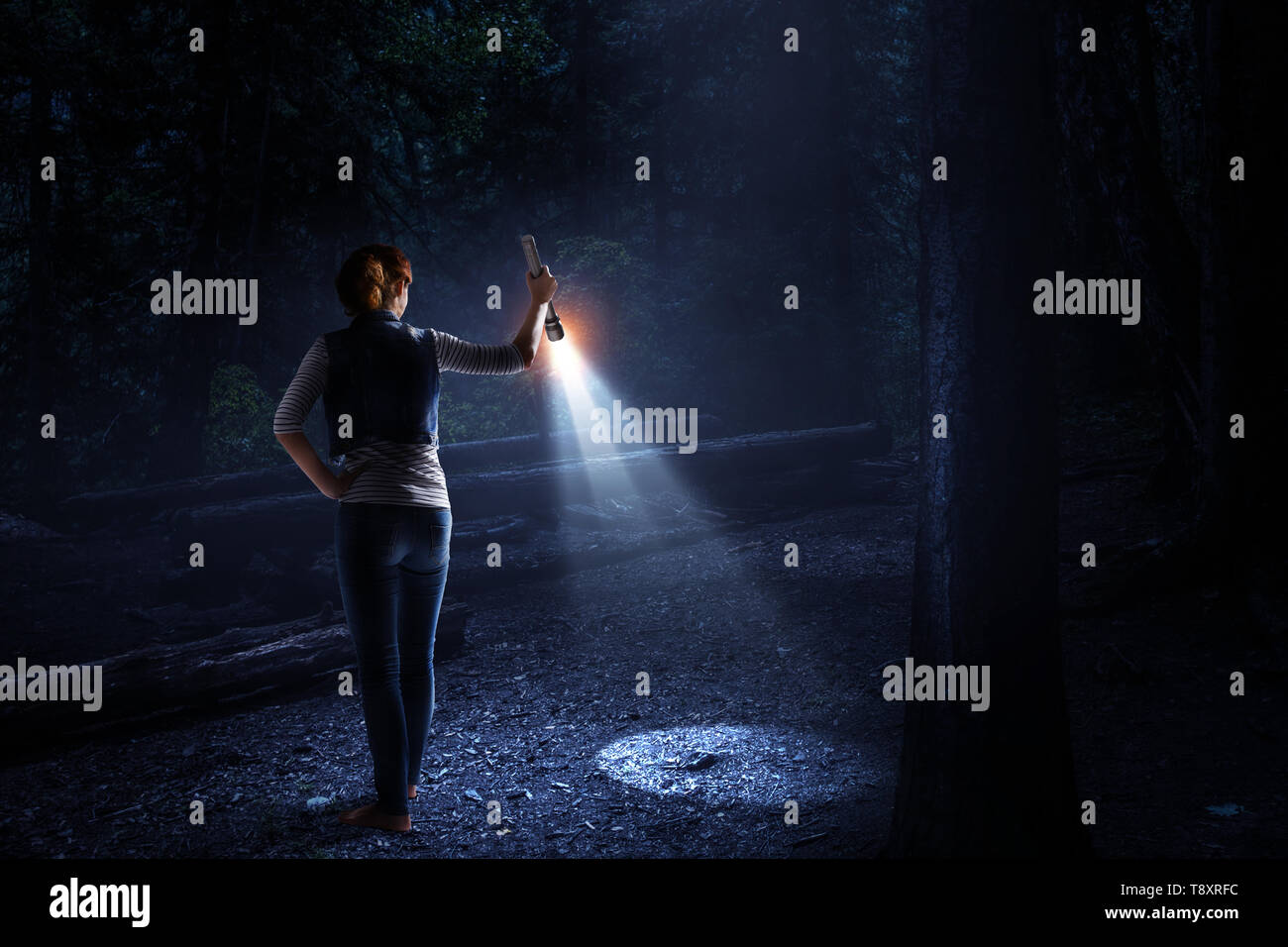 Young woman holding a flashlight Stock Photo - Alamy
