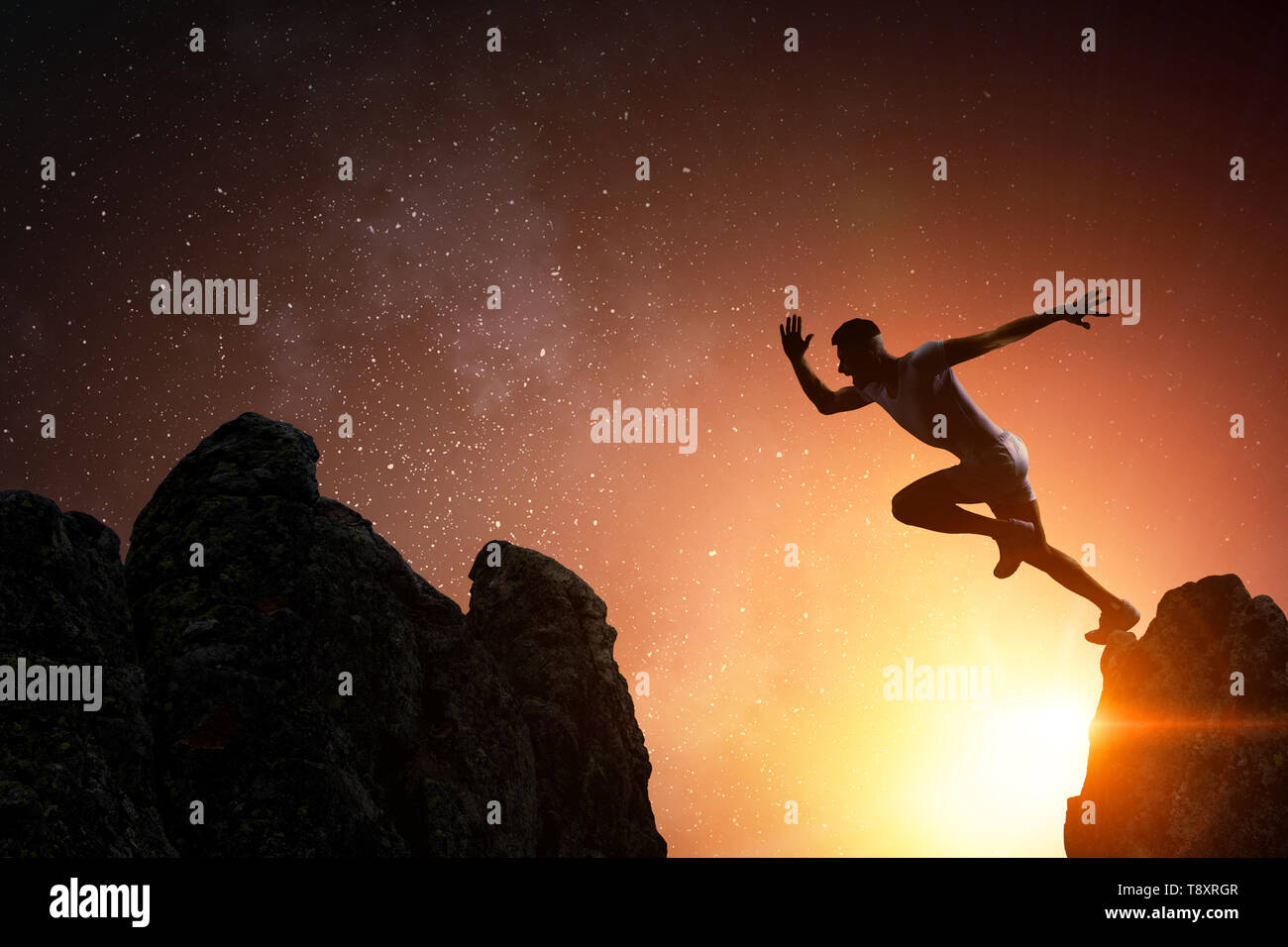 Man jumping over rocks hi-res stock photography and images - Alamy