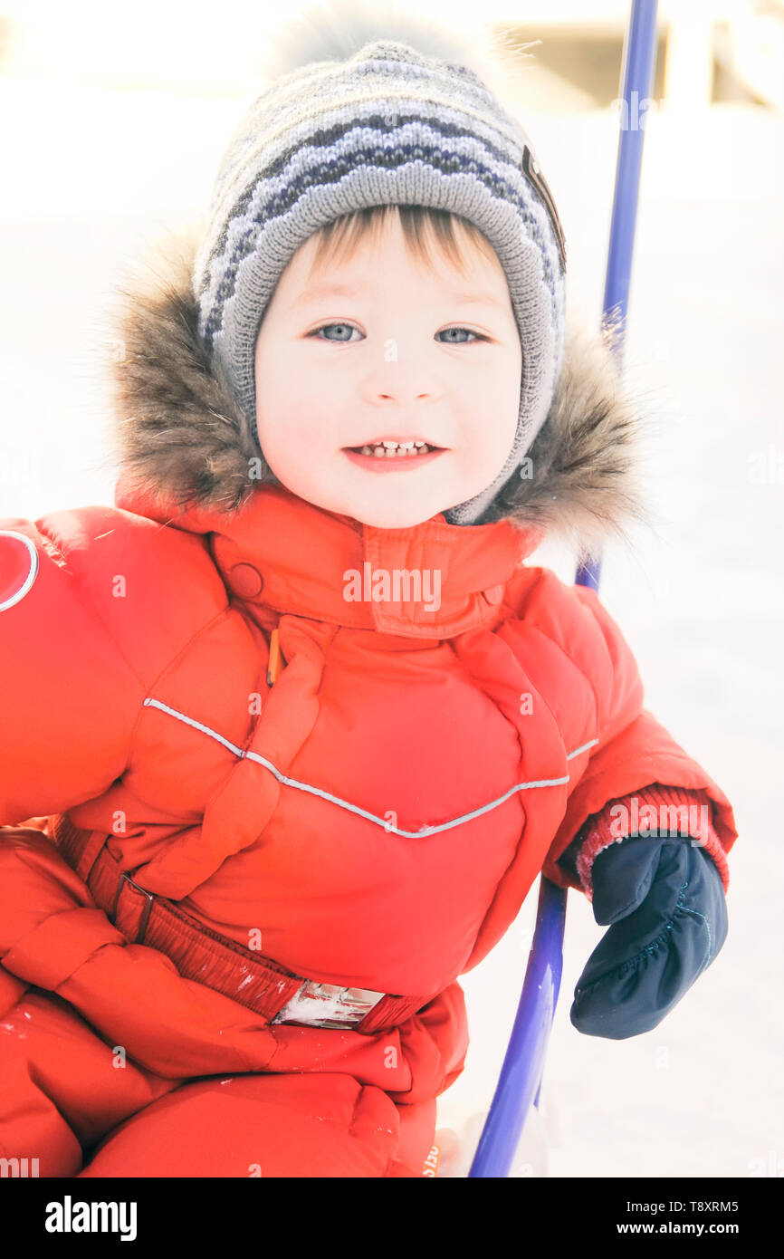 Portrait of a child in winter clothes, a walk through a winter park ...