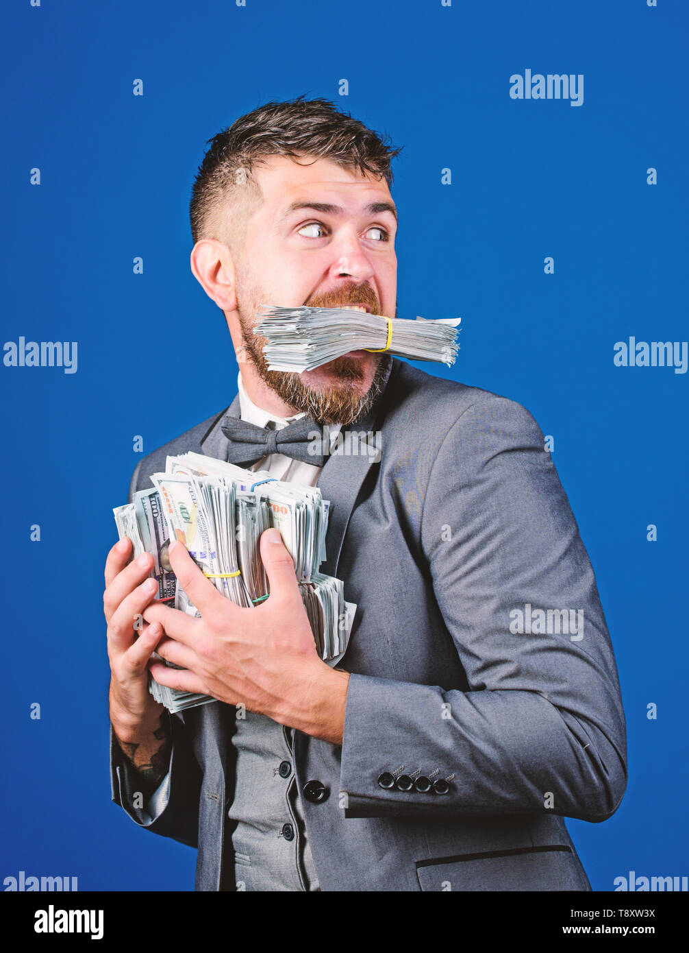 Businessman surprised feels like thief with lot of cash in hands. Steal ...