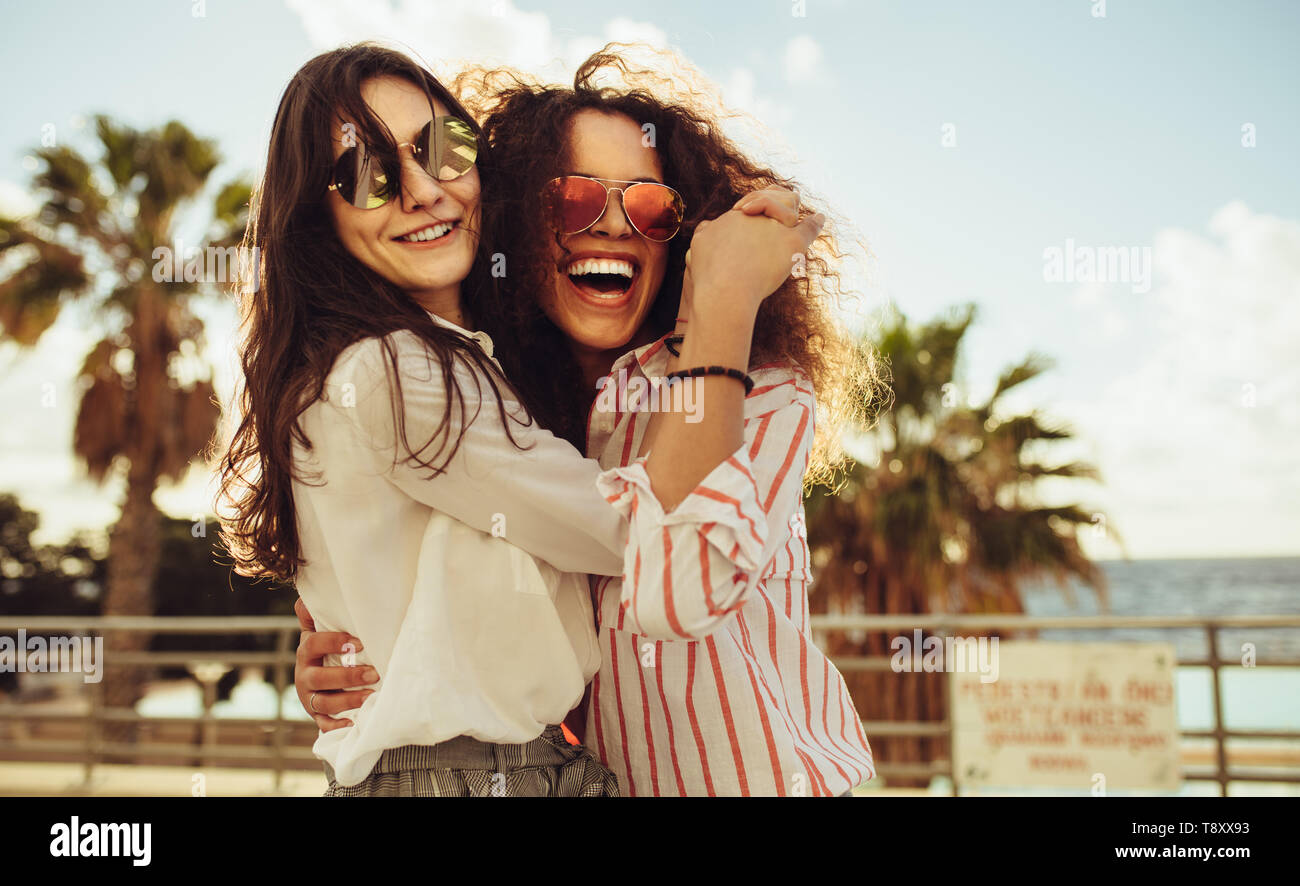Two girls hugging laughing hi-res stock photography and images - Alamy