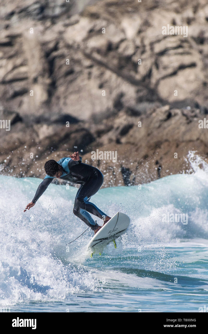 Spectacular surfing action as a surfer rides a wave in a jade coloured ...