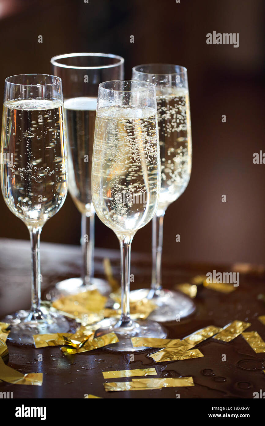Champagne Flutes In Golden Sparkle Background with golden confetti ...