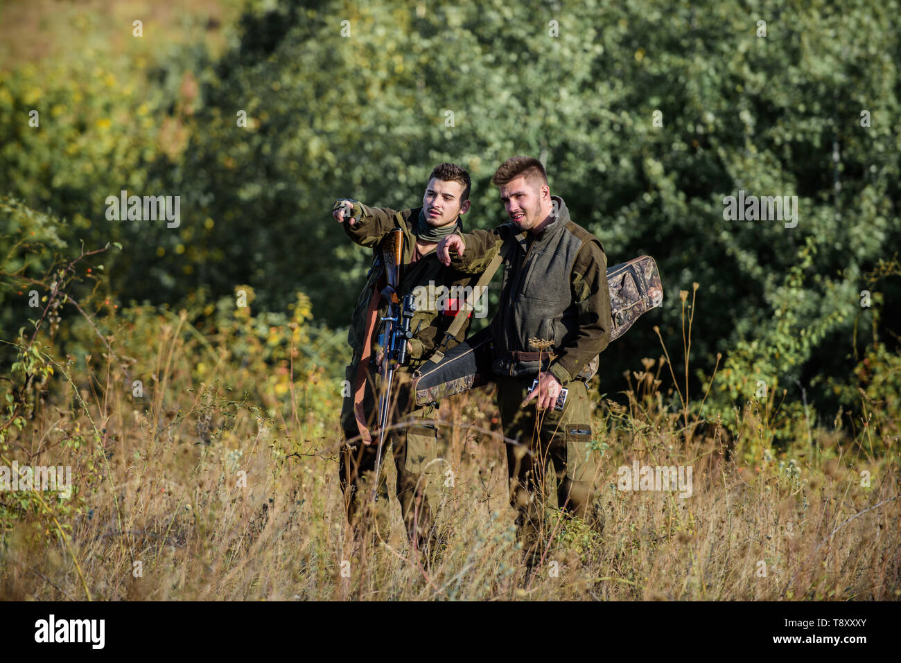Hunters friends enjoy leisure. Hunters with rifles in nature ...