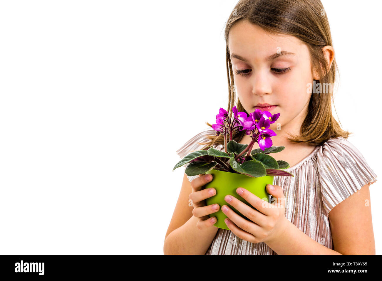 Sad young little girl holding flower pot mourning family loss. Child ...