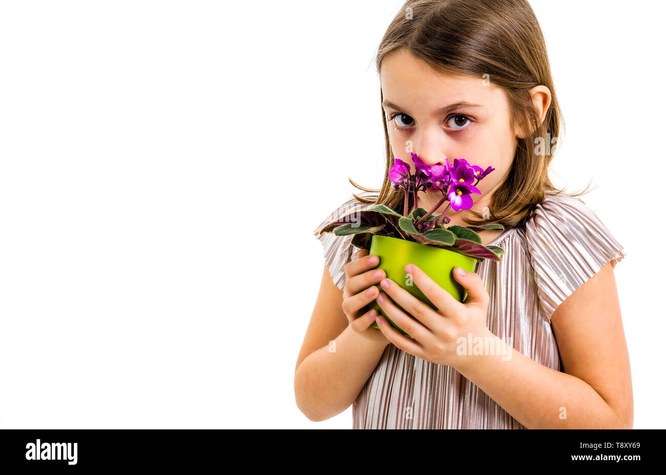 Sad young little girl holding flower pot mourning family loss. Child ...