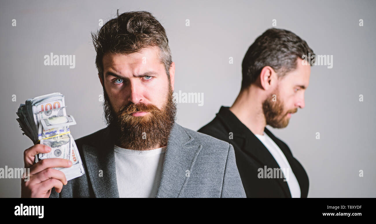 Scam and deception. Man bearded fraudster hold cash money while victim ...