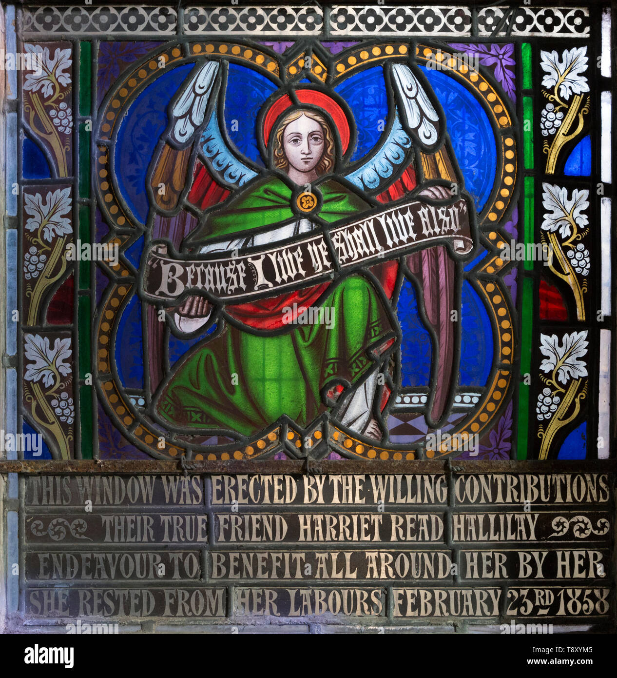 Victorian stained glass window detail depicting an angel holding ...