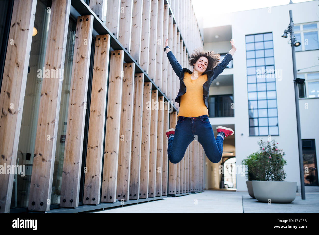 A young businesswoman jumping outdoors, expressing excitement Stock ...