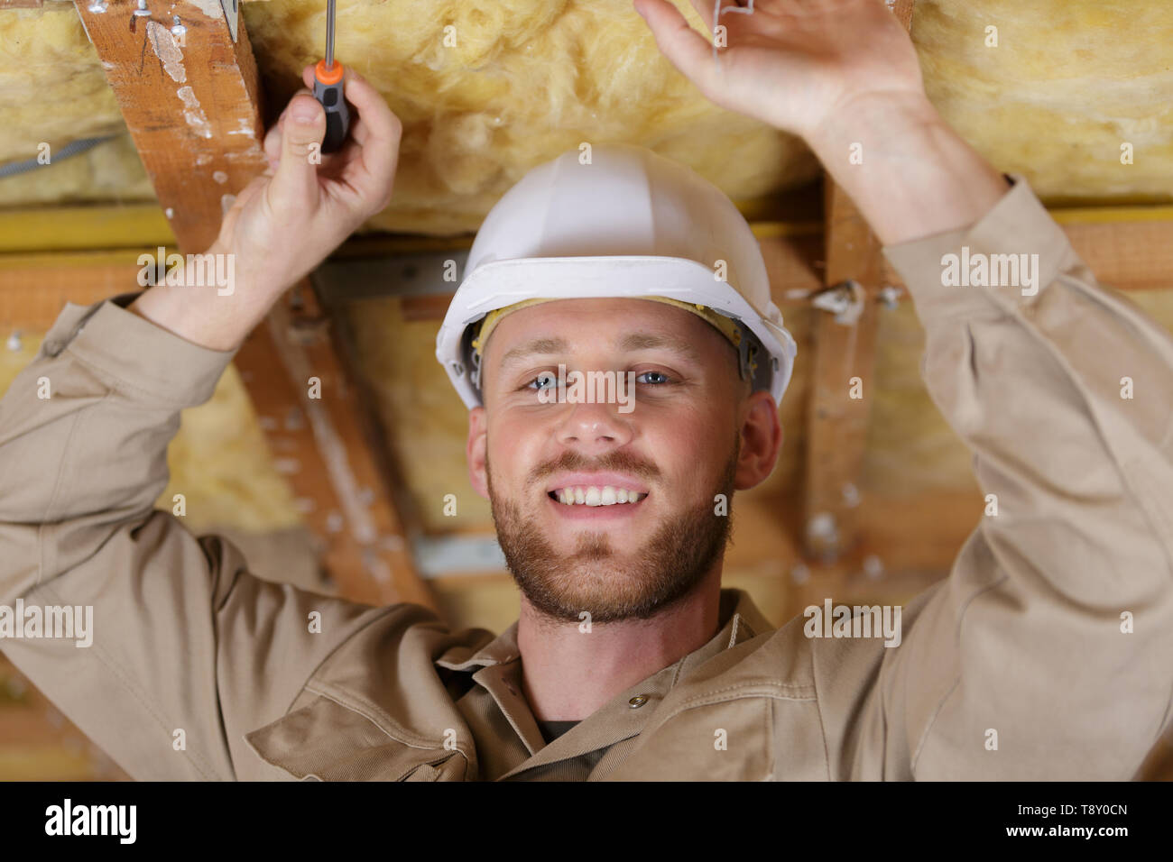 portrait of builder working on insulated ceiling Stock Photo - Alamy