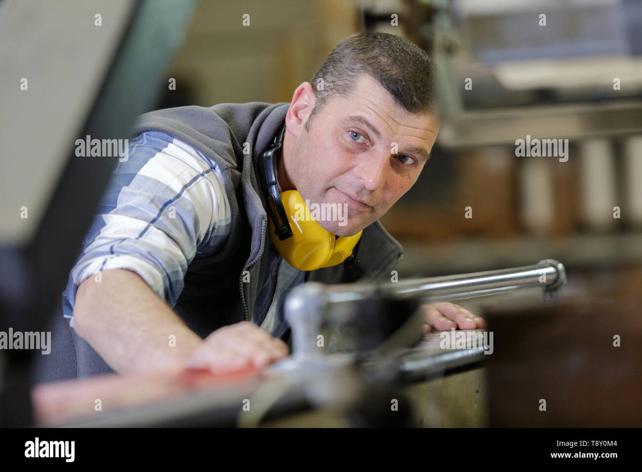 male factory worker using industrial machine Stock Photo - Alamy