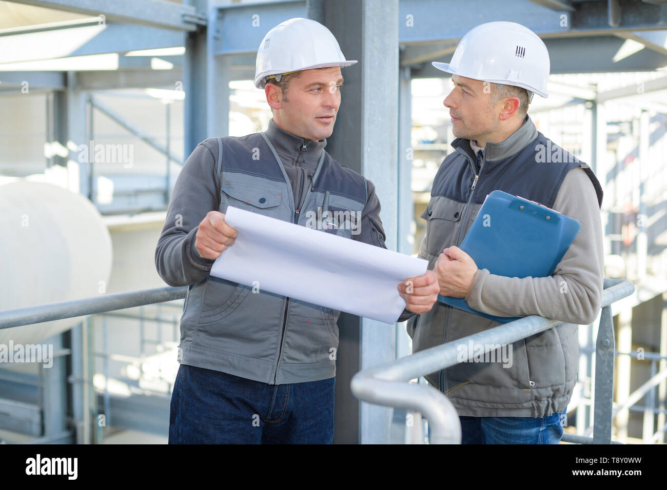 workers checking plans outdoors a plant Stock Photo - Alamy