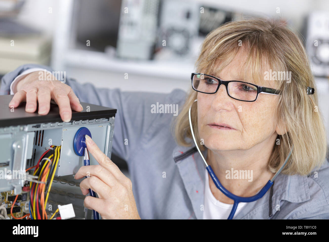 computer repair concept with woman inspecting with stethoscope Stock ...