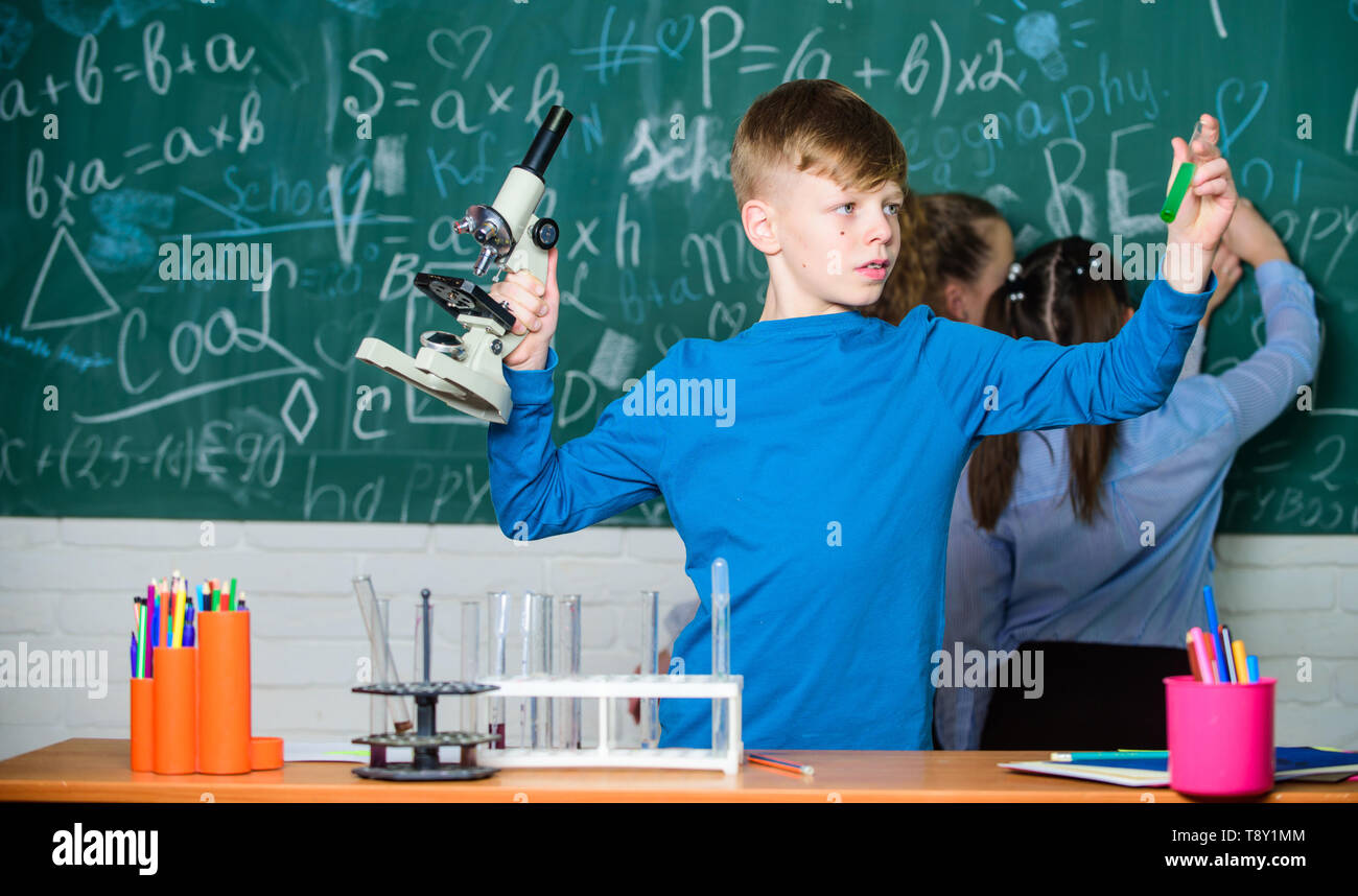 students doing biology experiments with microscope in lab. Happy ...