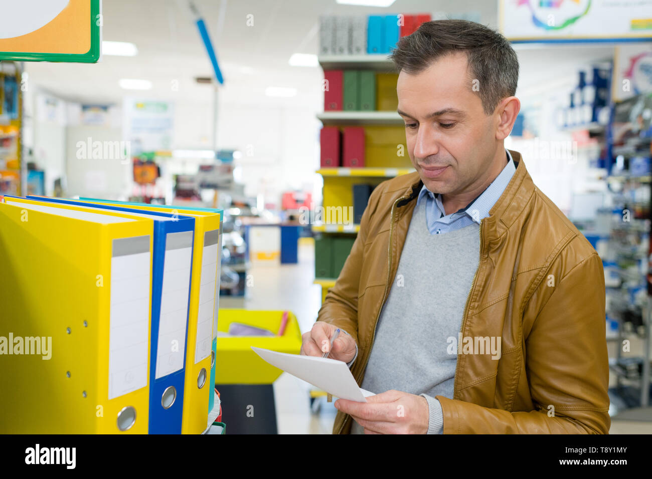 man with list in stationery store Stock Photo - Alamy