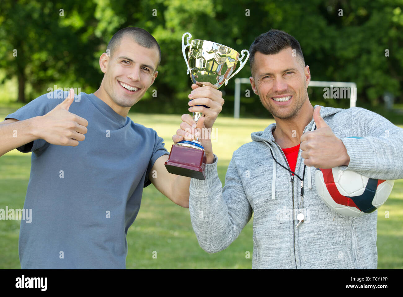men holding a trophy Stock Photo - Alamy