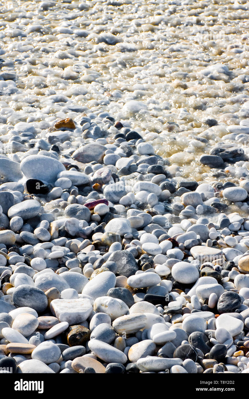 Rounded and smooth pebbles wet by seawater Stock Photo - Alamy