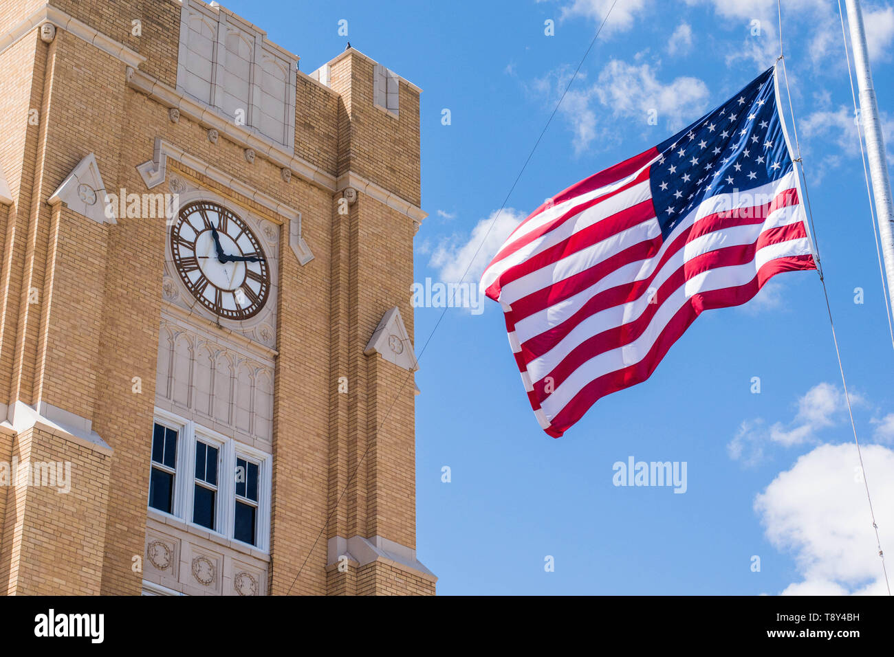 American flag next to clock tower Stock Photo - Alamy