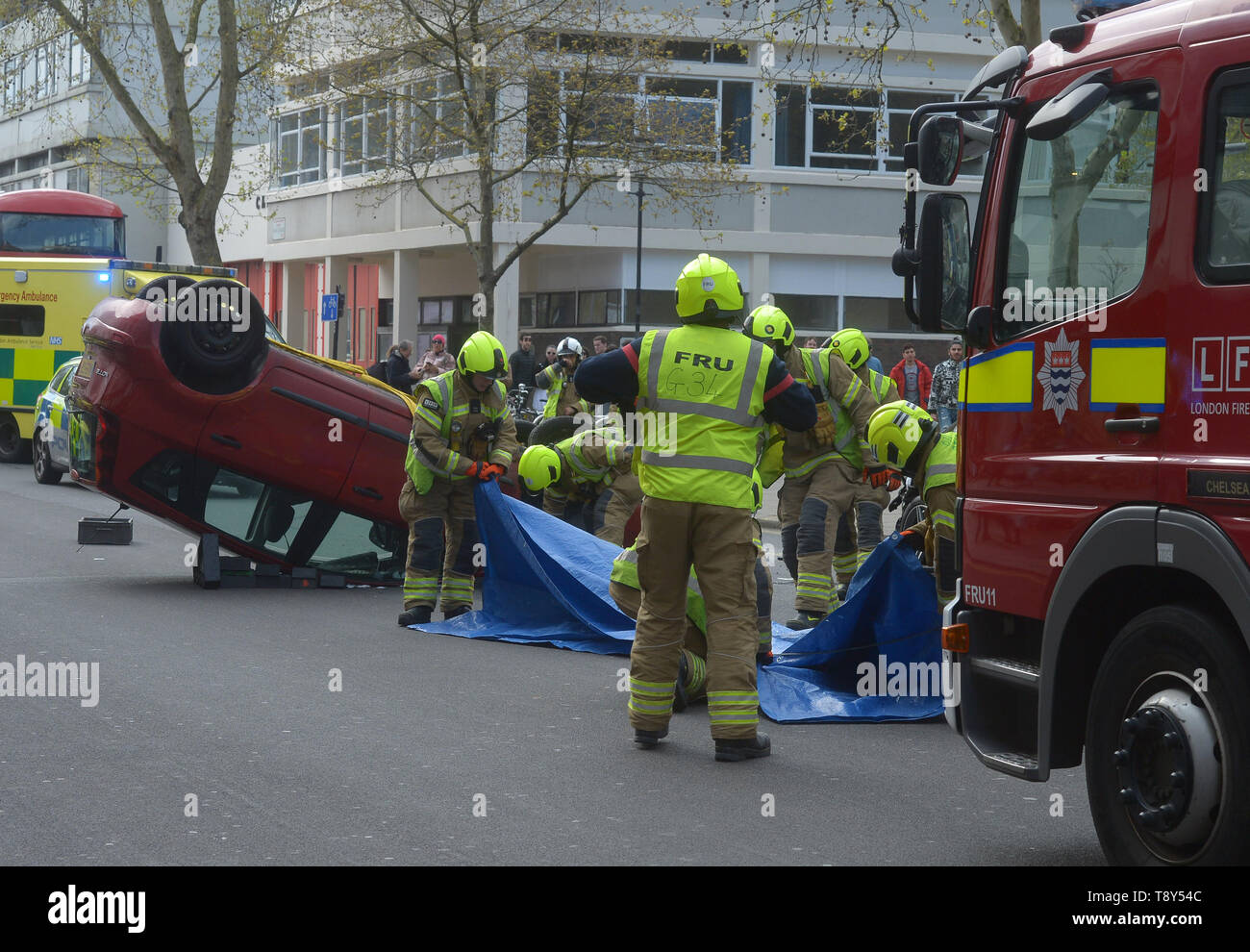 A car flips in an road traffic accident on Kings Road in Chelsea ...