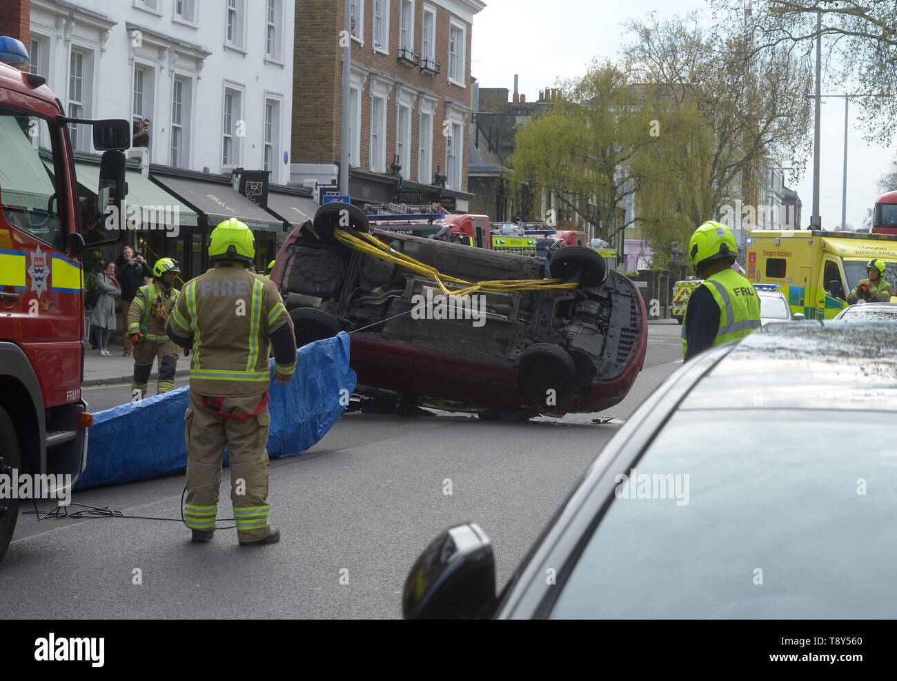 A car flips in an road traffic accident on Kings Road in Chelsea ...