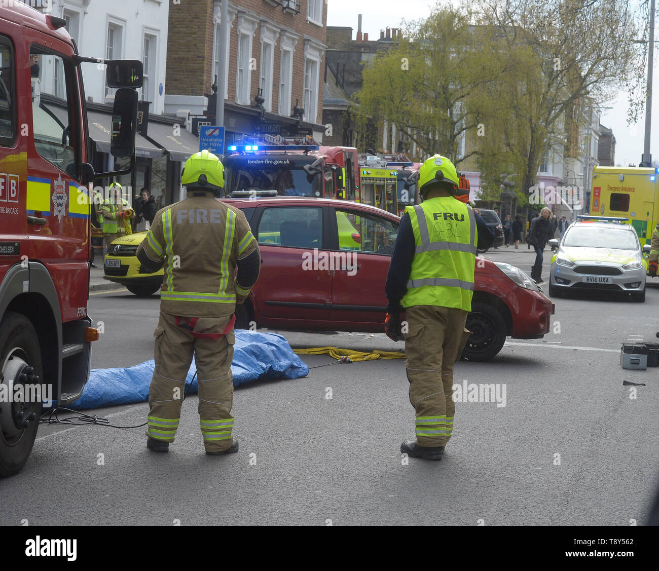 A car flips in an road traffic accident on Kings Road in Chelsea ...