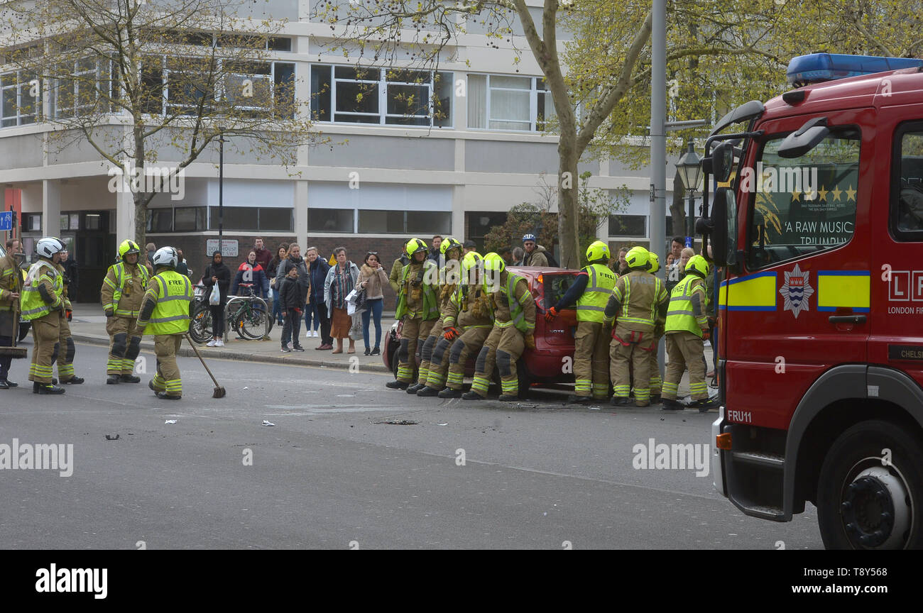 A car flips in an road traffic accident on Kings Road in Chelsea ...