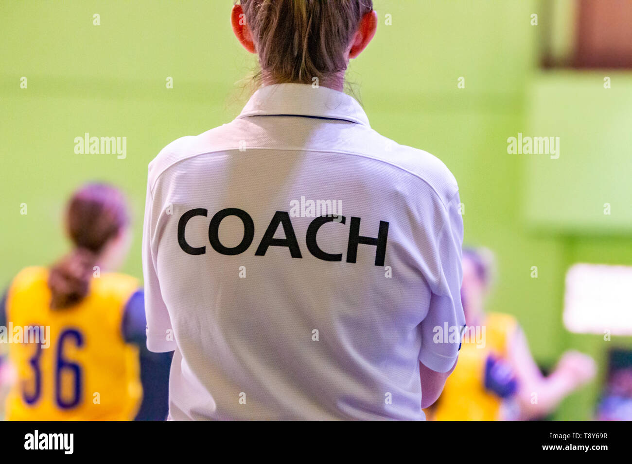 Female coaches in white COACH shirt at an indoor sport game Stock Photo ...